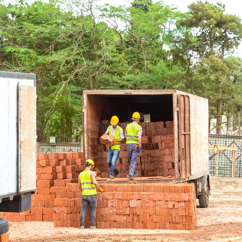 Construction Workers Unloading Bricks Editorial Photo - Image of blocks ...