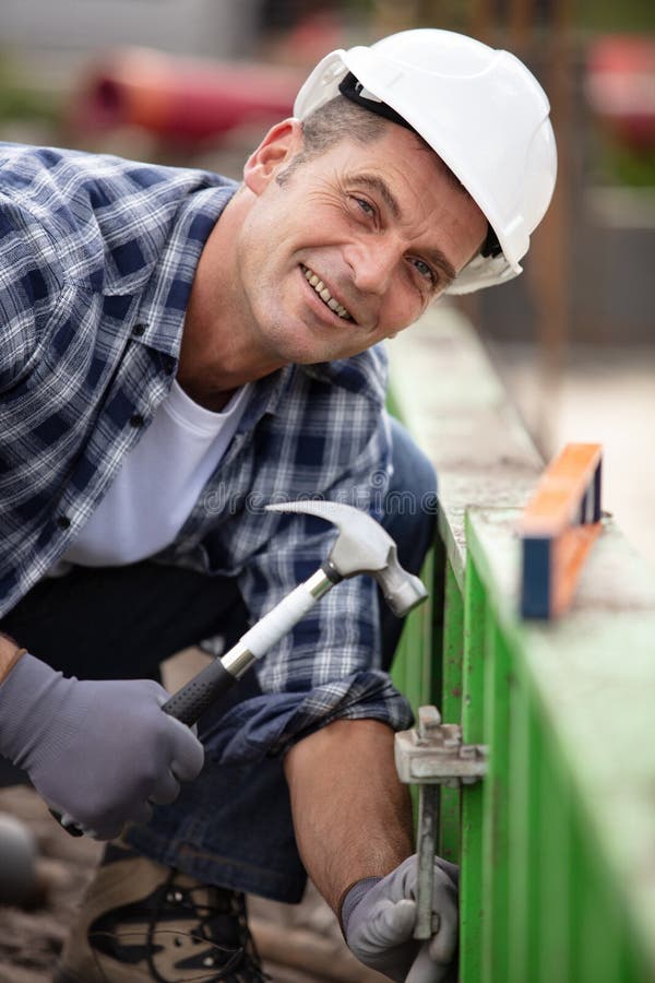 Construction Workers Use Hammer at Building Site Stock Photo - Image of ...