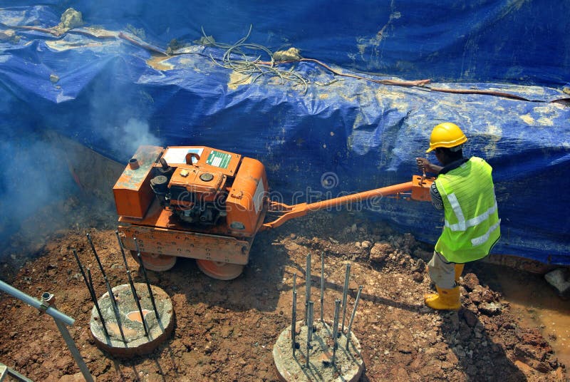 Construction Workers Using Baby Roller Compactor Stock Photo - Image of ...