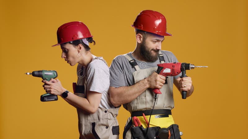 Construction Workers Using Power Drill Gun To Work on Industrial ...