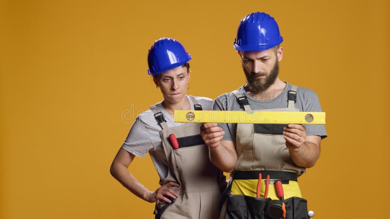 Construction Workers Using Water Level Tools To Measure Flat Surface ...