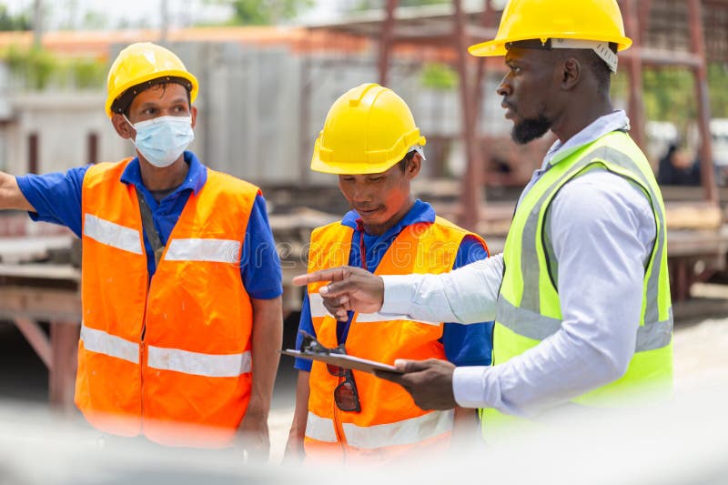 Construction Workers at Work, Foreman and Worker Team Discussing at ...