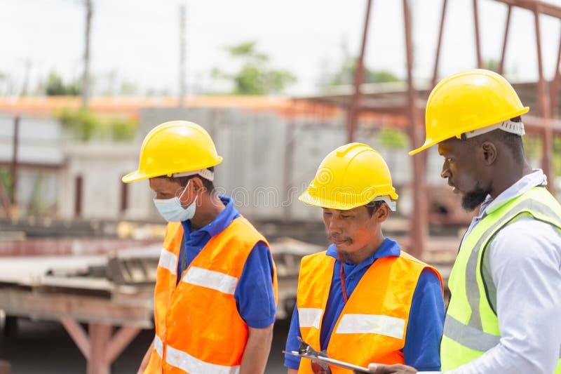 Construction Workers at Work, Foreman and Worker Team Discussing at ...