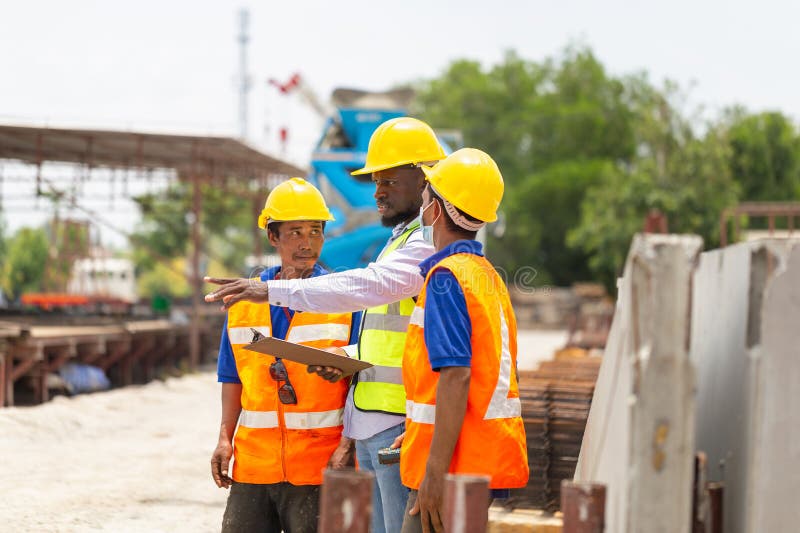 Construction Workers at Work, Foreman and Worker Team Discussing on ...