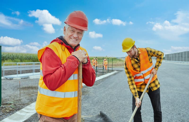 Construction Workers at Work on Construction Site during Road Paving ...