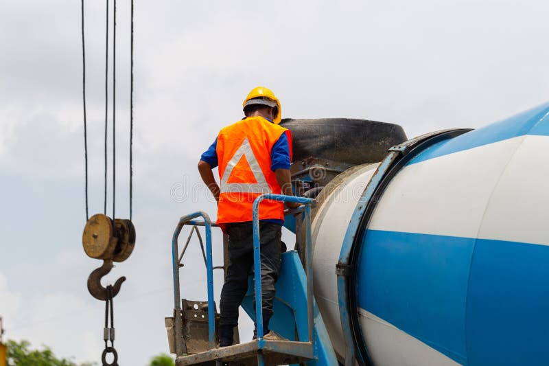 Construction Workers at Work, Worker Man on Concrete Mixer Trucks at ...