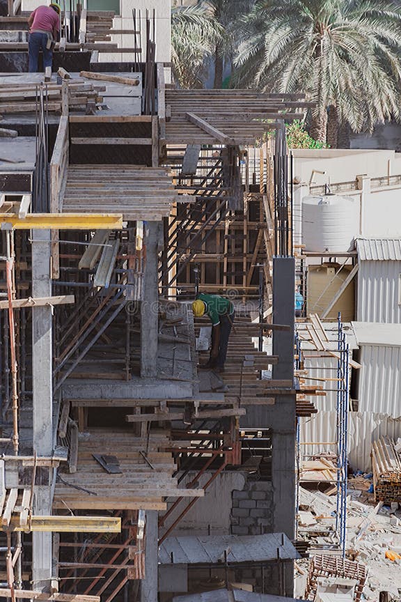 Construction Workers Working on a Building Site Wearing Helmet ...