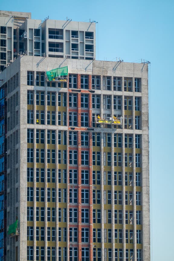 Construction Workers are Working on the Exterior Wall Under the ...