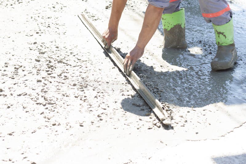 Construction Workers are Working by Leveling the Concrete Floor Smooth ...