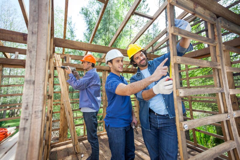 Construction Workers Working in Wooden Cabin Stock Photo - Image of ...