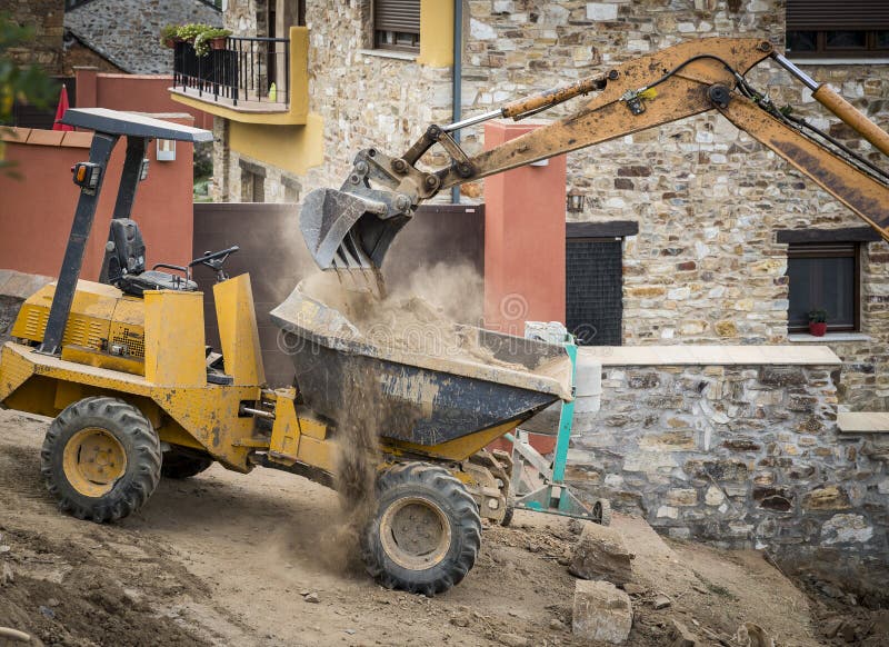 Construction Works with an Excavator and a Mini Dumper Truck Stock ...