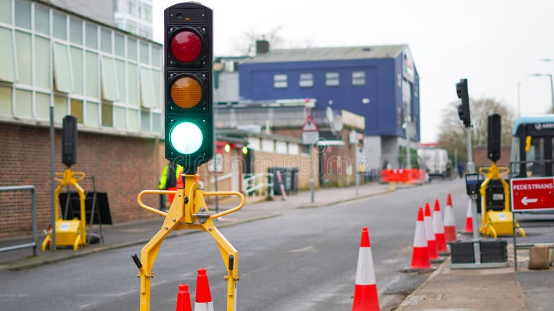 A Construction Zone with Active Roadwork and Traffic Lights Regulating ...