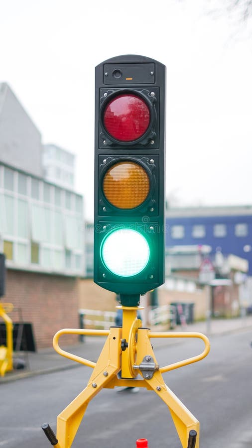A Construction Zone with Active Roadwork and Traffic Lights Regulating ...