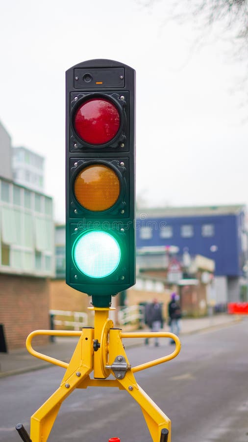 A Construction Zone with Active Roadwork and Traffic Lights Regulating ...
