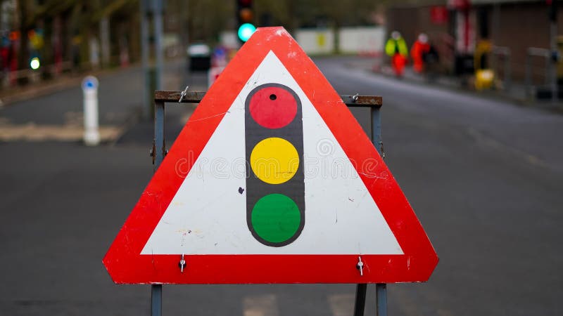 A Construction Zone with Active Roadwork and Traffic Lights Regulating ...
