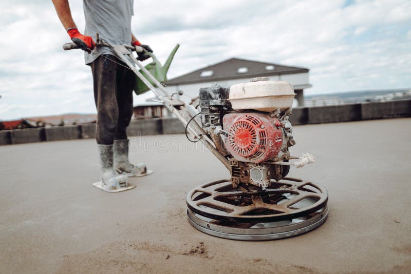 Worker with Power Trowel Tool Finishing Concrete Floor, Smooth Concrete ... Worker with Power Trowel Tool Finishing Concrete Floor, Smooth Concrete ...