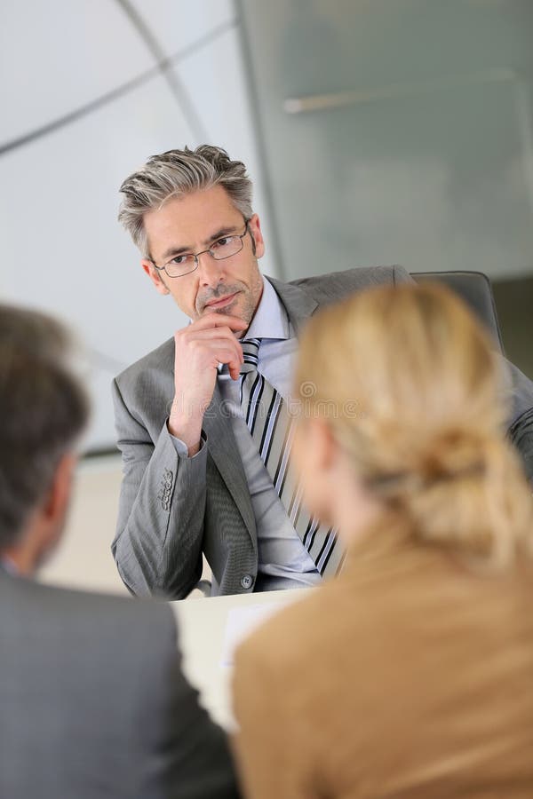 Consultant Listening To Clients during Meeting Stock Image - Image of ...
