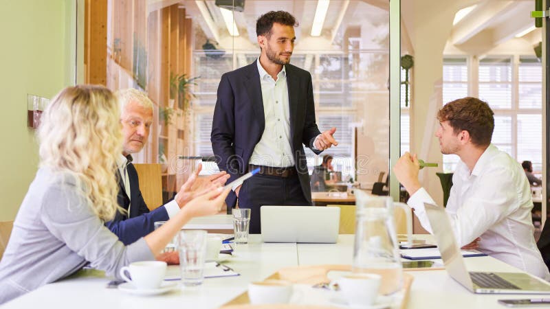 Consulting Man in a Discussion with Business People I Stock Image ...