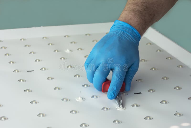 A Consumer Electronics Technician Removes a White LED Panel on an LCD ...
