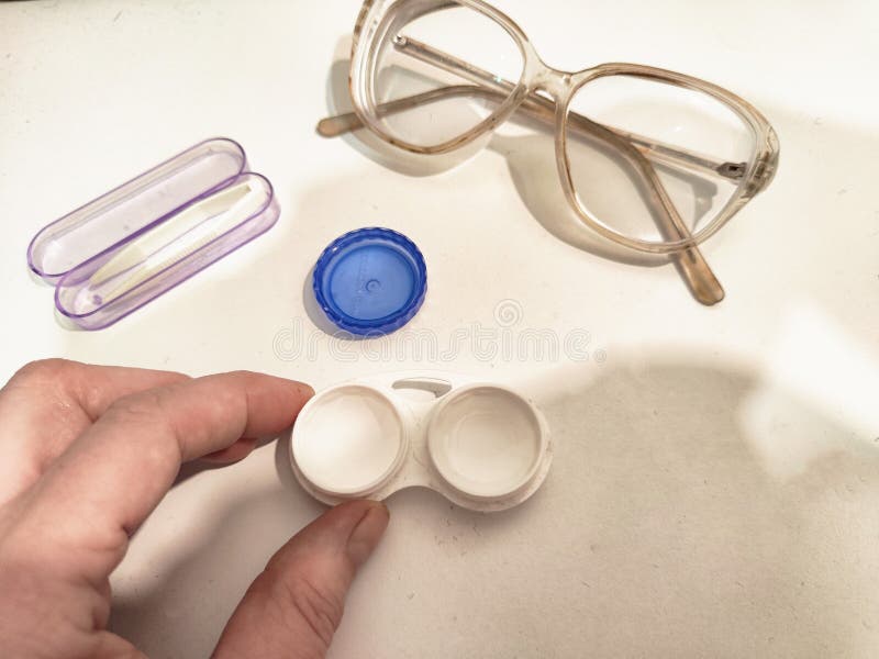 Contact Lens Case and Glasses on a Table during daily Eye Care Routine ...
