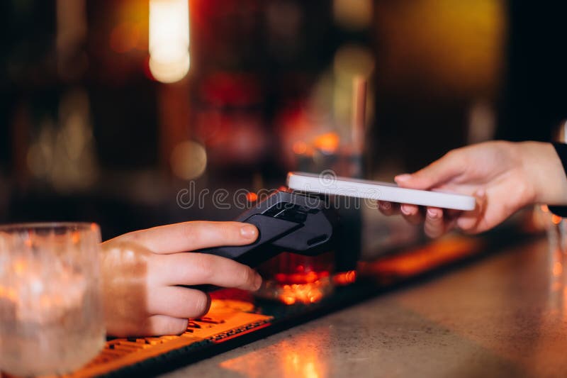 Contactless Mobile Payment in Action at a Stylish Modern Bar Stock ...