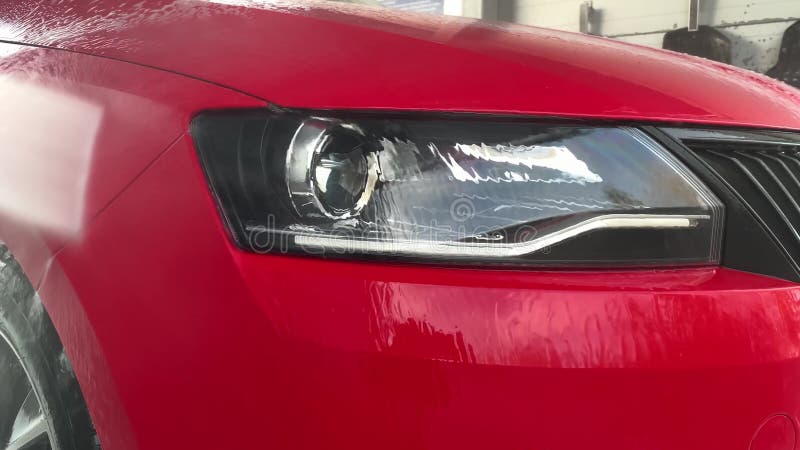 Contactless Washing of a Red Car, Cleanliness and Shine of Headlights ...