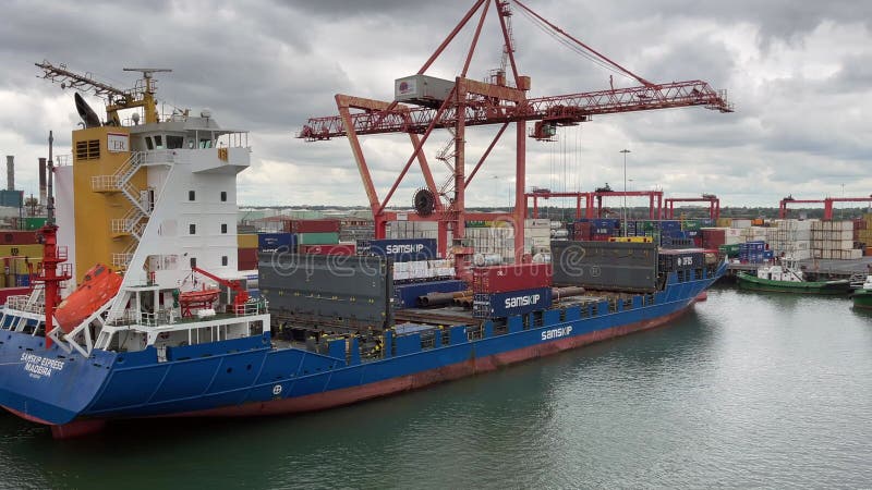 A Crane Loading Scrap in Cargo Ship Vessel at Recycling Metal Plant ...