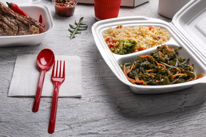 Container with Delicious Food on Wooden Table. Delivery Service Stock ...