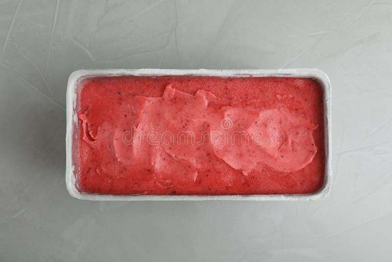 Container with Delicious Pink Ice Cream on Grey Table, Top Stock Photo ...