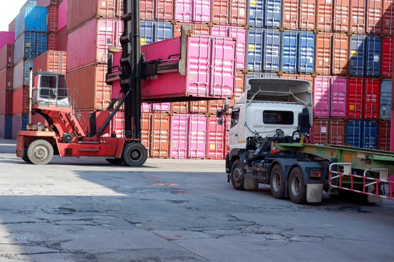 A Container Forklift Sits Behind a Stack of Containers Stock Photo ...