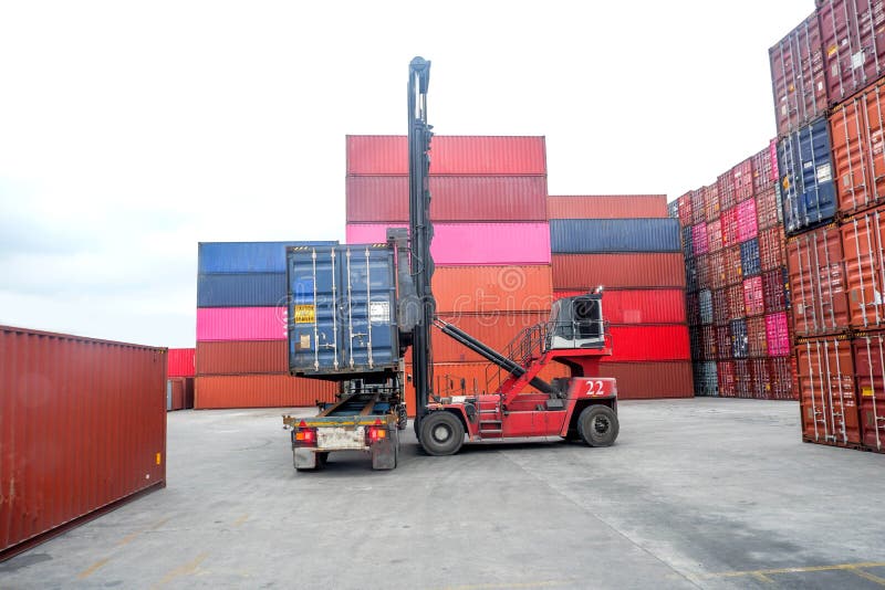 Container Handlers Put Containers into Work Trucks in the Harbor Stock ...