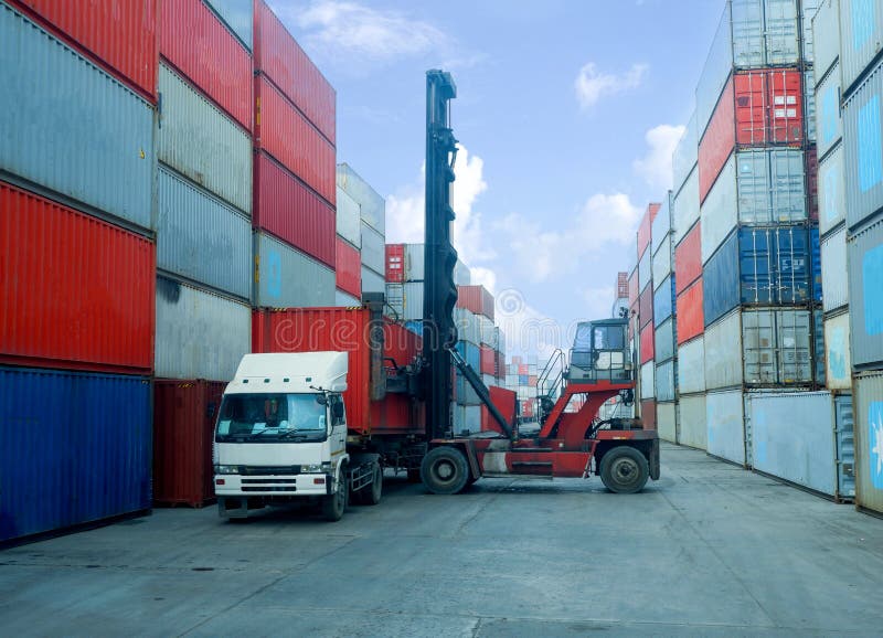 Container Handlers Put Containers into Work Trucks in the Harbor Stock ...