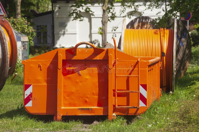 Container, Orange Skip for Building Rubble Standing on a Meadow Stock ...