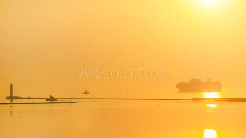 Container Ship Arrives a Port during Beautiful Sunset. the Ship Sails ...