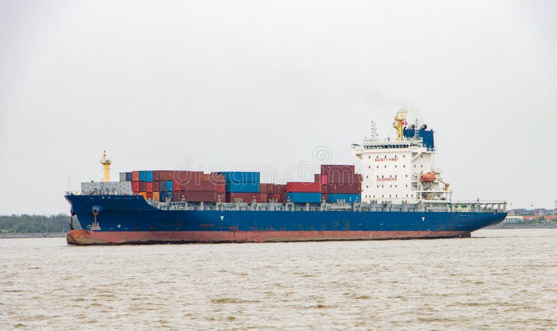 The Container Ship Loaded of Containers Sail beside a Seashore Stock ...