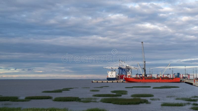 The Container Ship is Loaded at the River Cargo Port Stock Image ...