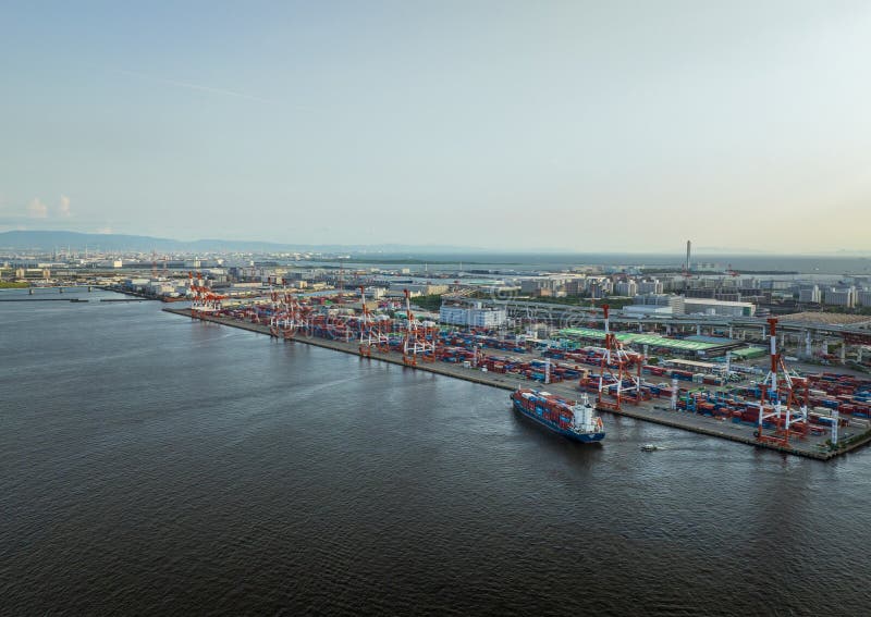 Container Ship Maneuvers into Docking Position Under Loading Cranes ...