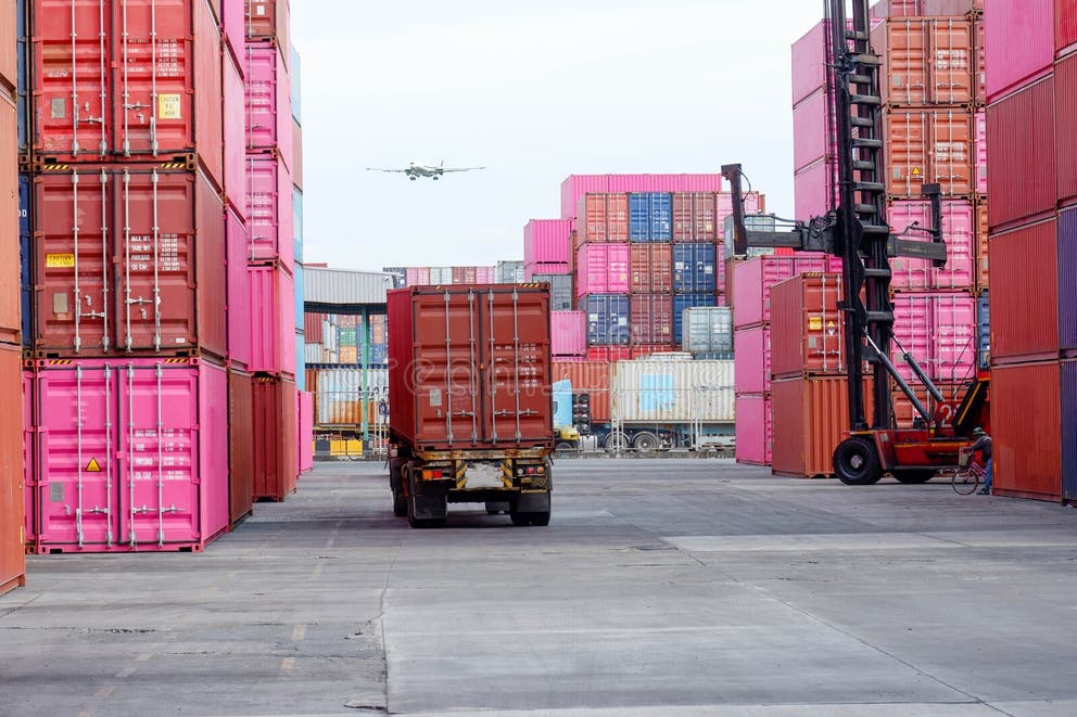 A Container Storage Yard and Forklifts are Operating Under a Partly ...