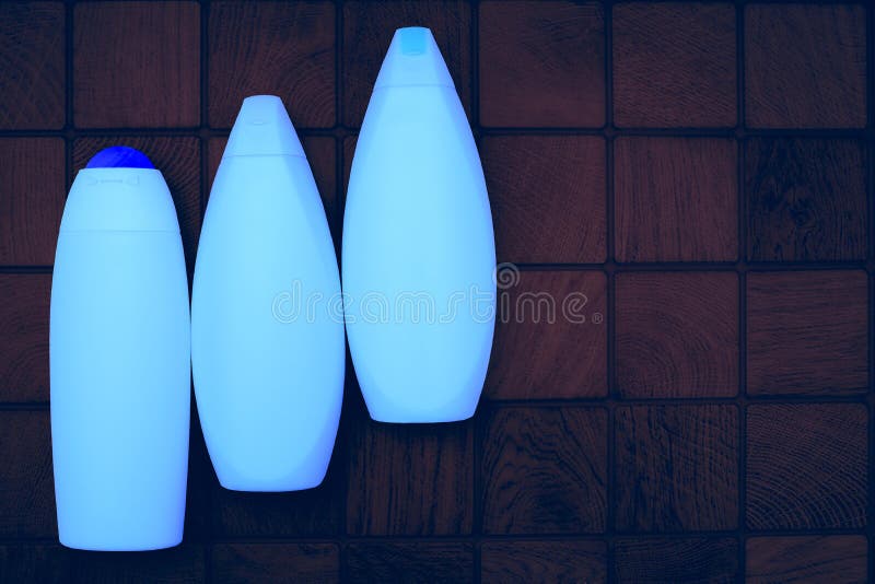 Three Plastic Bottle for Detergents on the Background of Dark Brown ...