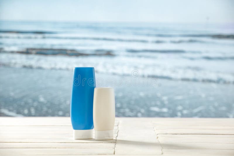 Containers for Sun Tan Lotion and Sunscreen Oils on a Bright Table with ...