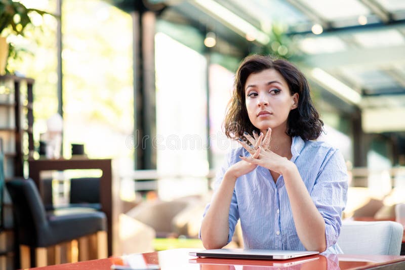 Contemplated Young Woman in Cafe with Laptop Stock Photo - Image of ...