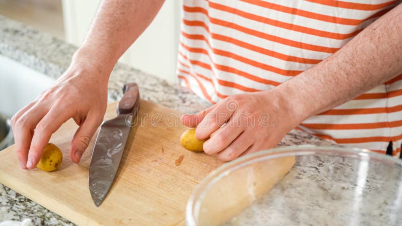 Young Man Enthusiastically Preparing Dinner in Modern Kitchen Stock ...
