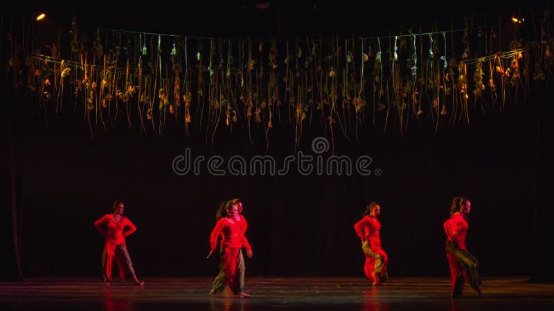 Contemporary Dance Performance with Dancers in Red Under Dramatic ...