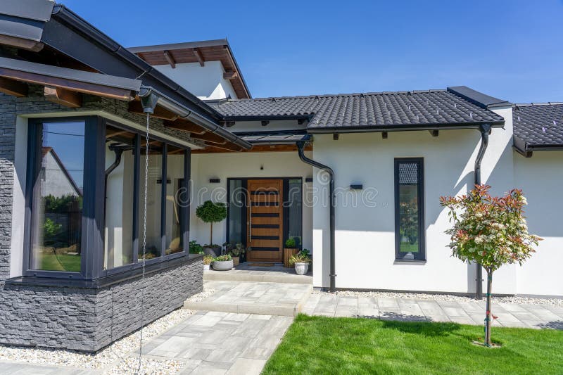 A Contemporary House Entrance Showcasing Sleek Architecture, Greenery ...