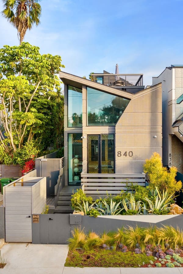 Contemporary House with Lush Greenery in Bright Sunlight Stock Photo ...