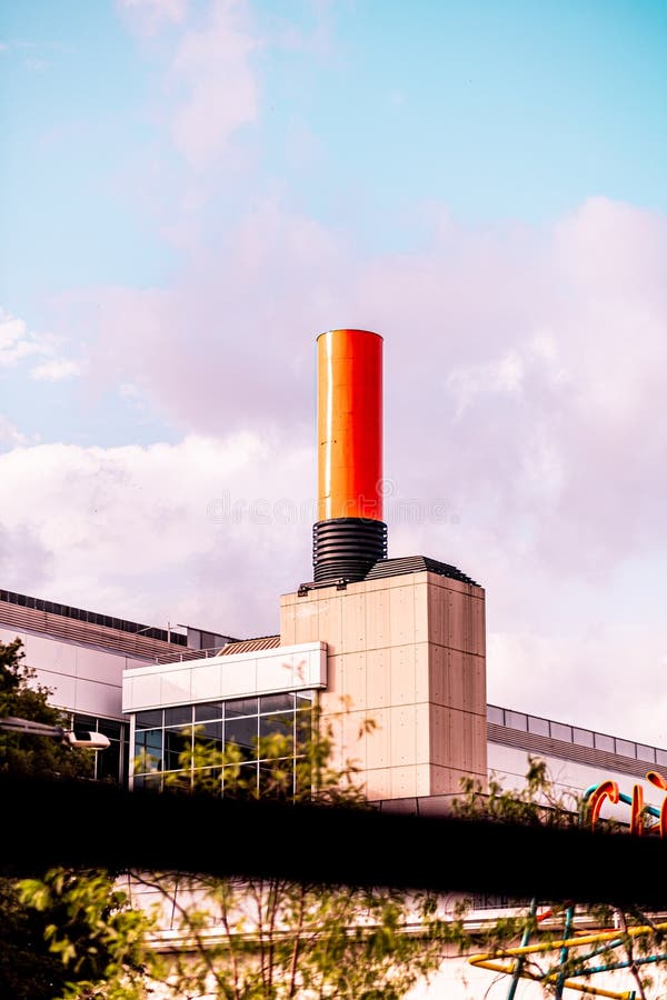 Modern Industrial Facility with Prominent Orange Ventilation Tower ...