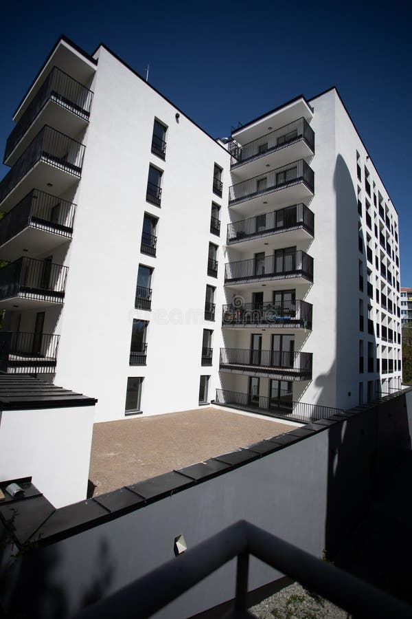 A Contemporary Modern Apartment Complex Featuring Balconies and an ...