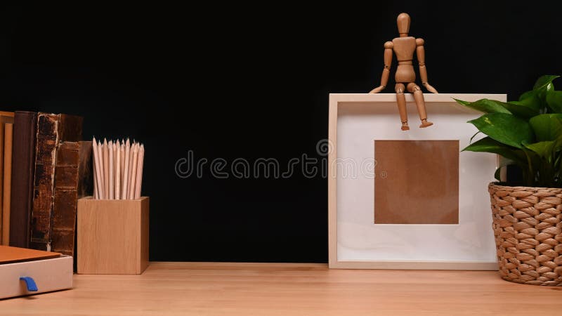 Workplace with Empty Frame, Pencil Holder and Old Books on Wooden Table ...