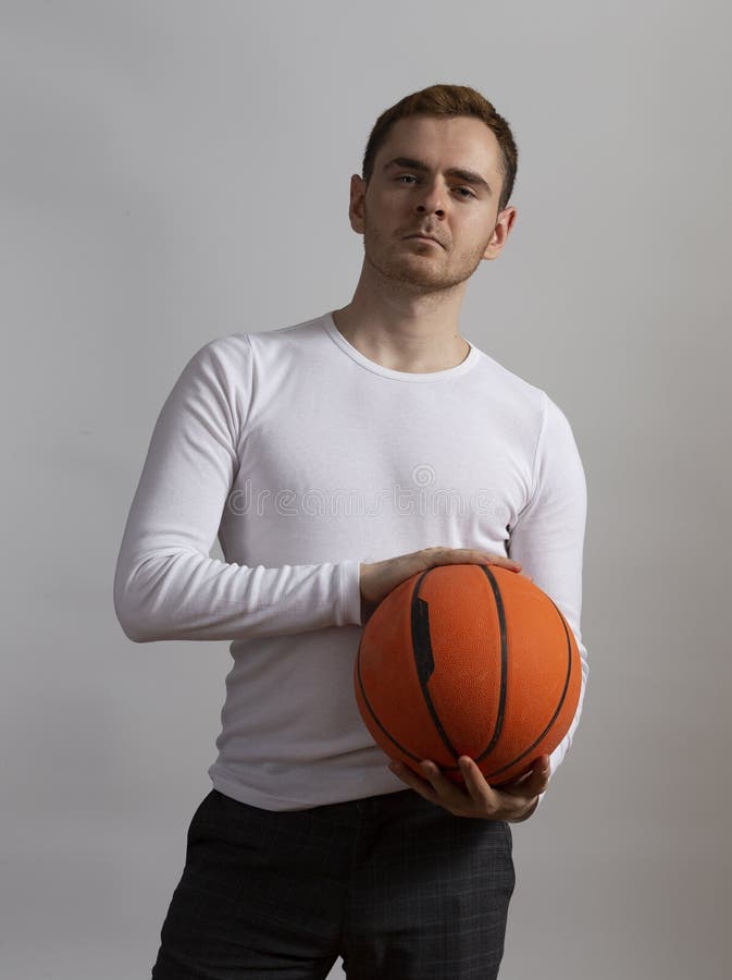Contemporary Young Man Poses in Studio.with a Basketball Stock Photo ...