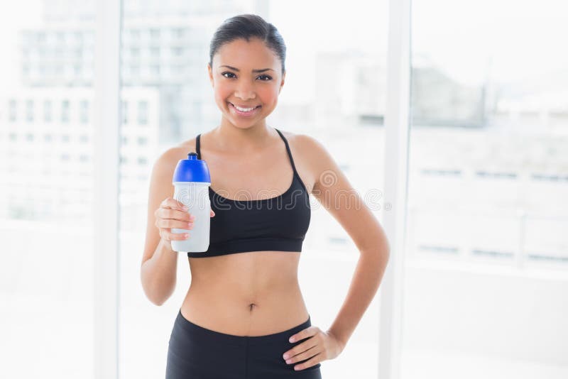 Dynamic Dark Haired Model In Sportswear Posing With Hands On The Hips